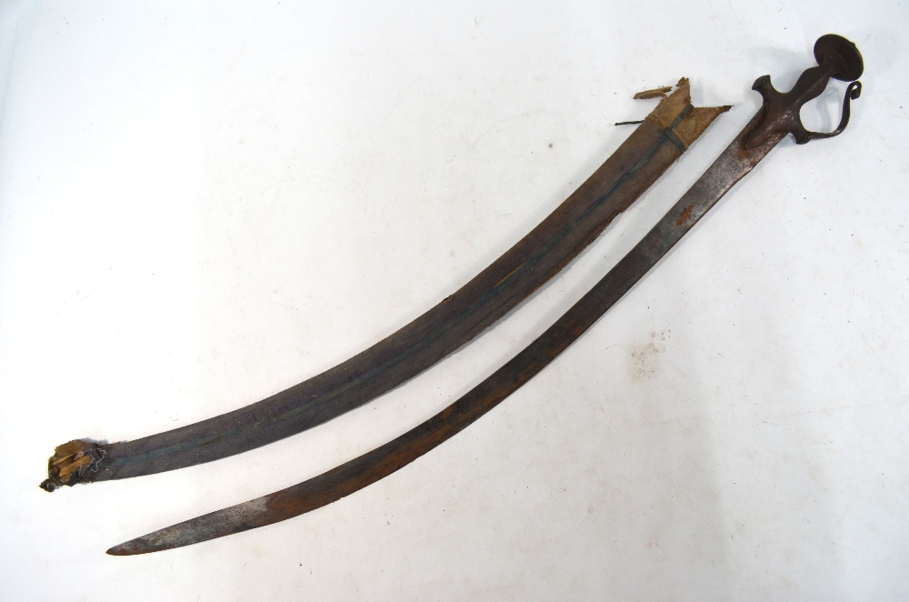 An Indian talwar with typical curved blade and hilt, in a fitted ...