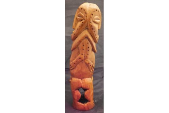 An African craved ivory fertility symbol of phallic form as a male and ...