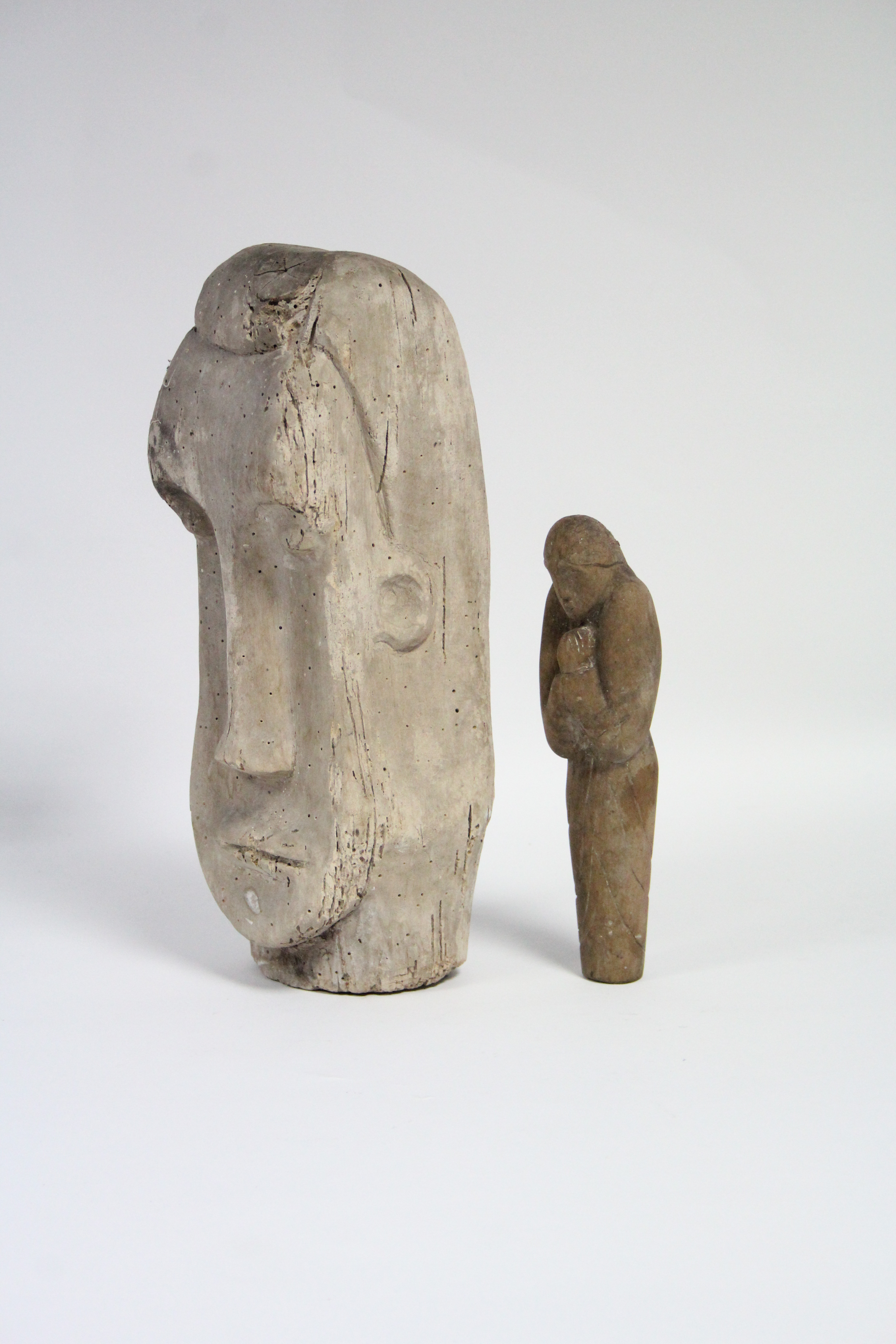 An ethnic carved wood stylised human head, 13” high (w.a.f.); & another ...