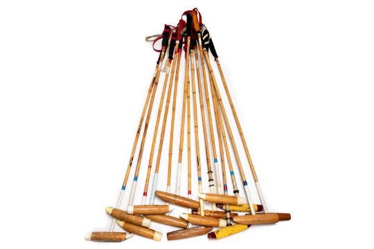 A collection of fourteen vintage polo sticks, makers including Salter ...