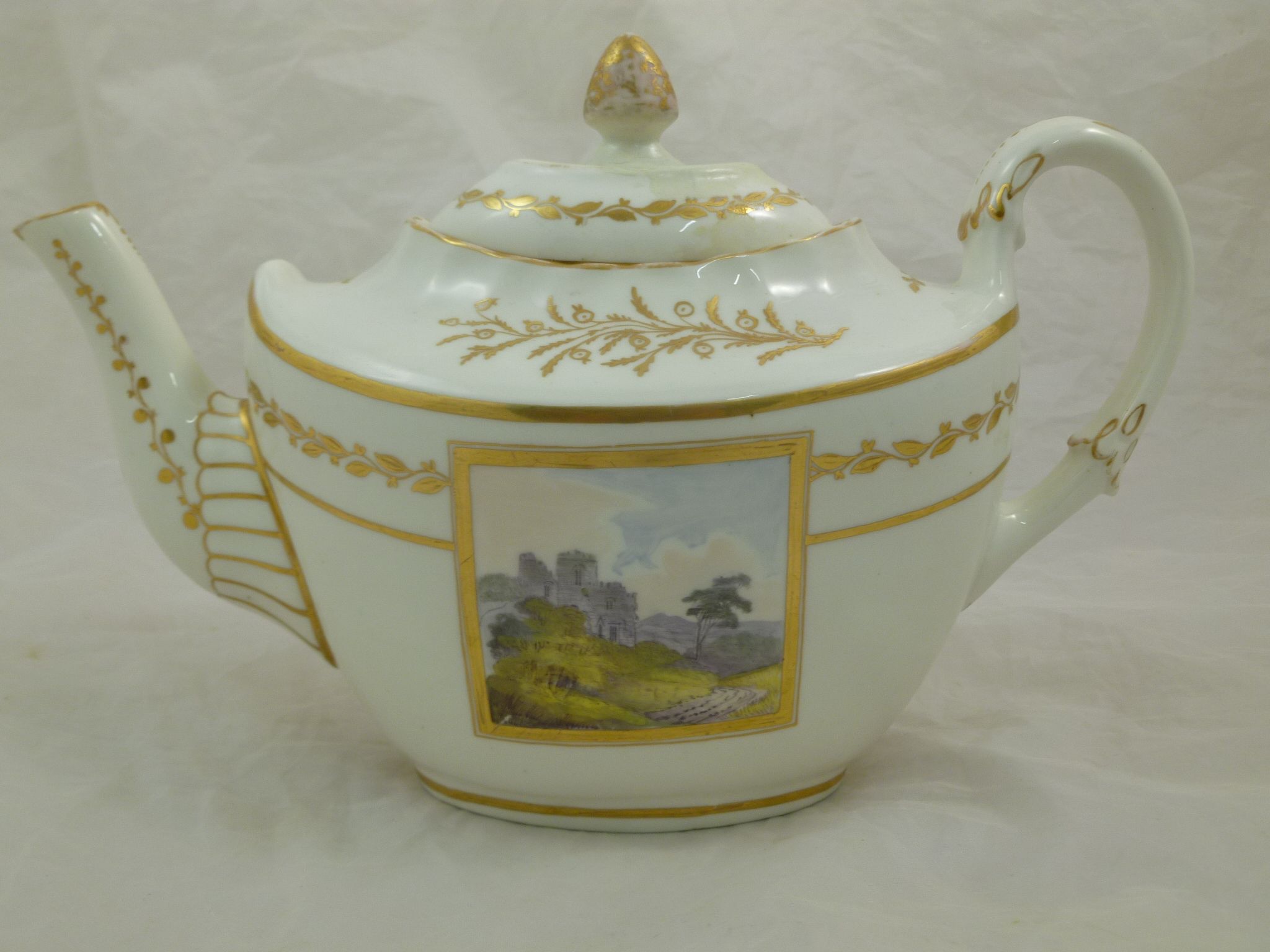 A Pinxton porcelain teapot decorated in gilt with hand painted ...