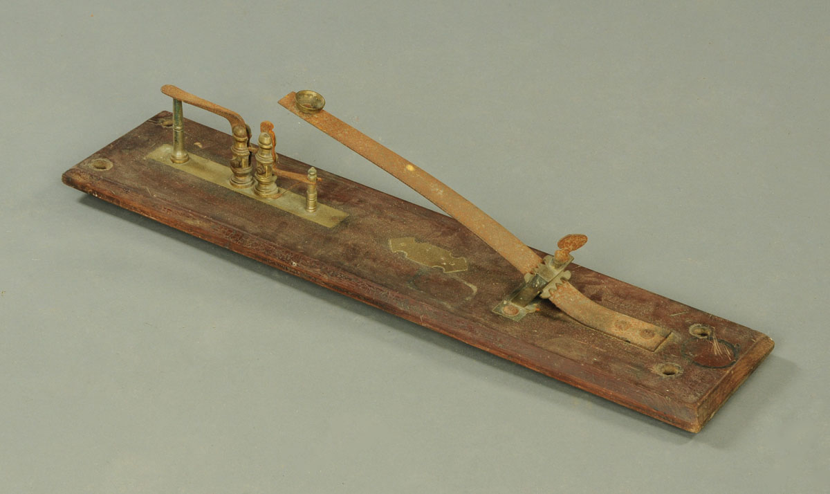 A 19th century Knurr and Spell game, with brass fitting, raised on a ...