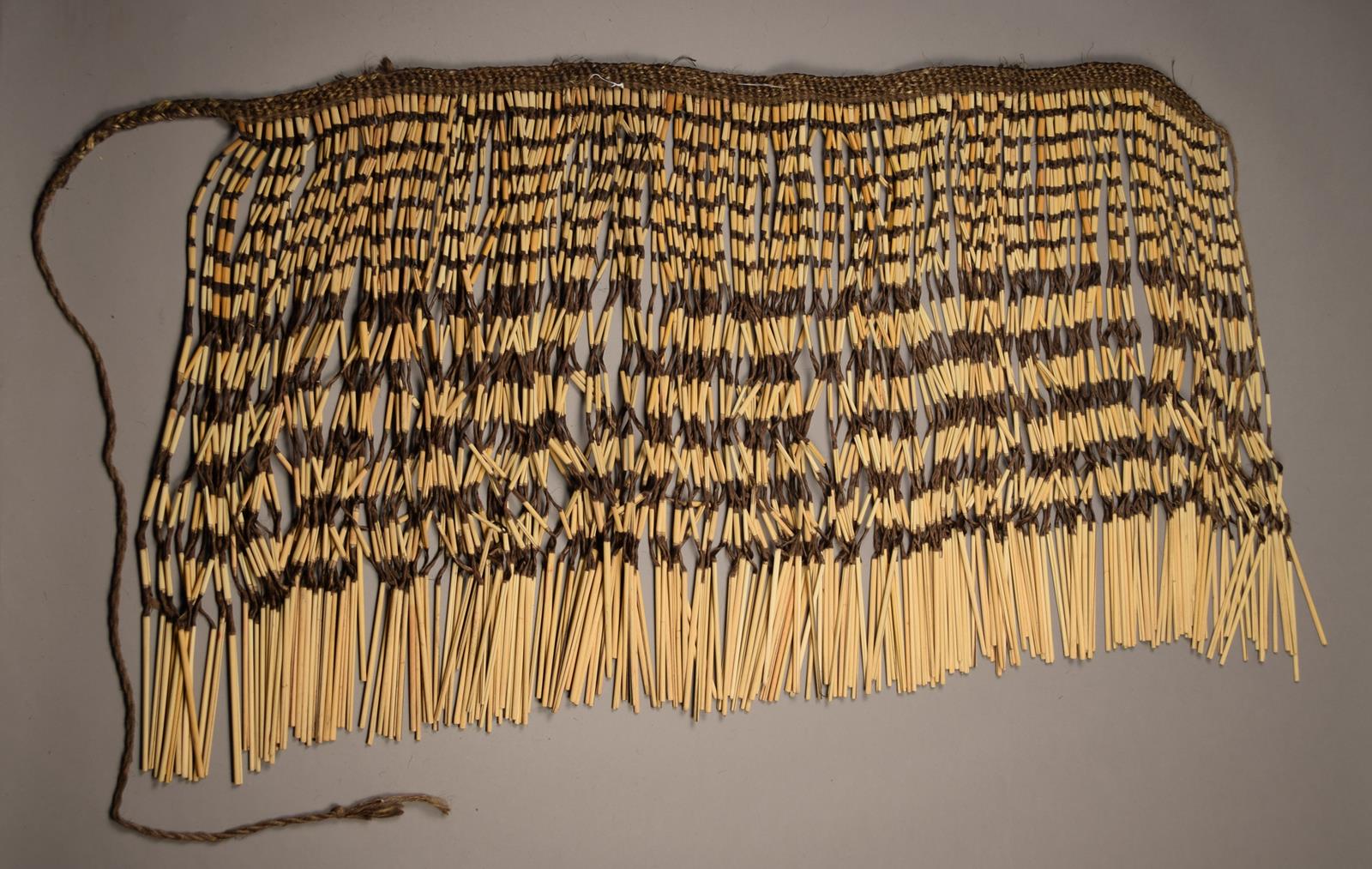 A Maori piu piu New Zealand flax and fibre, with a woven band hung with ...