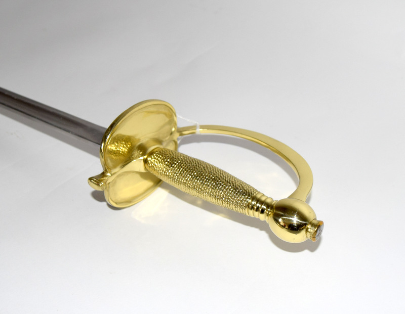 A single edged sword with gilt hilt and knuckle guard in its scabbard ...