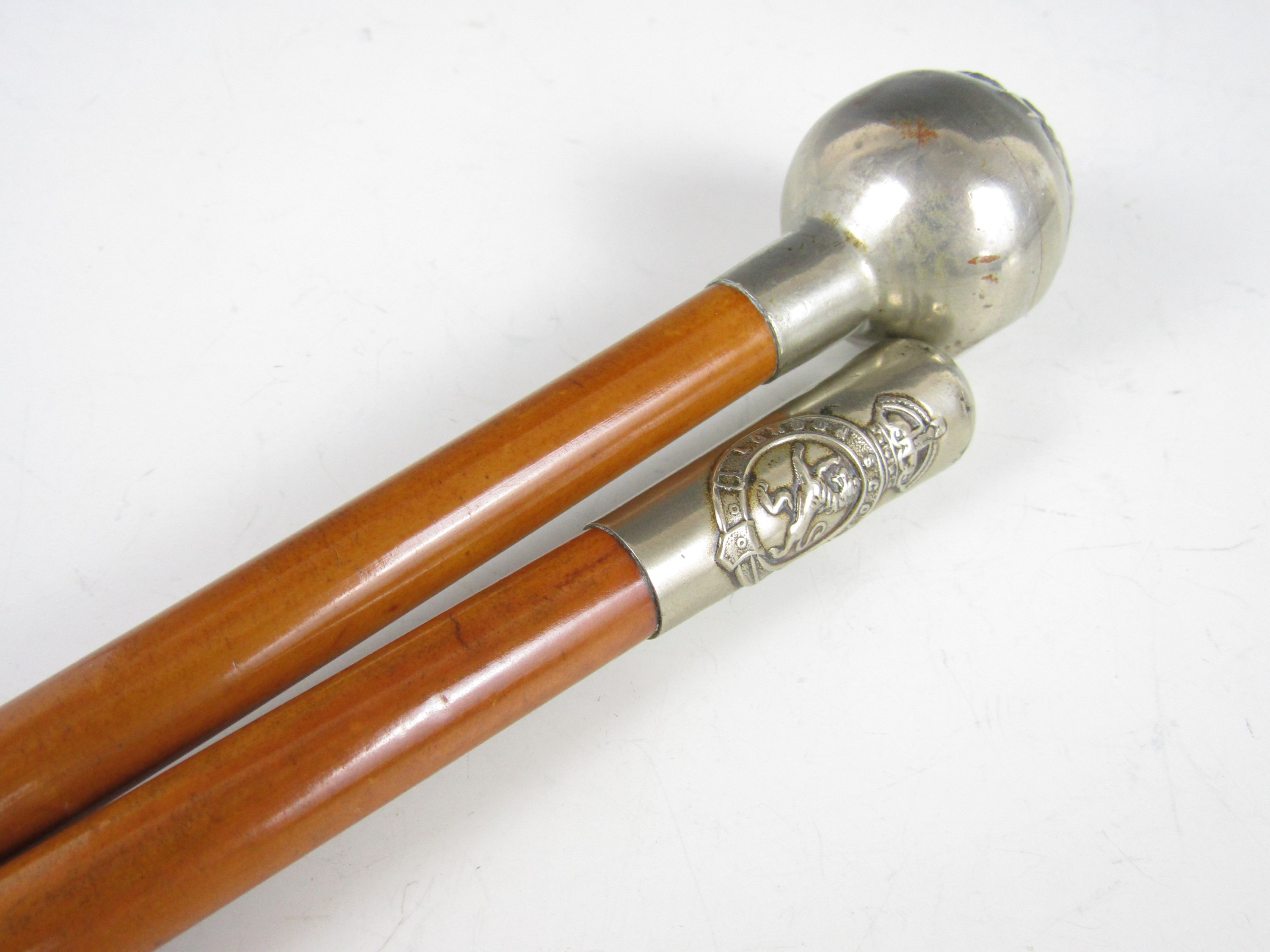 Two London Scottish swagger sticks, each having a nickel pommel