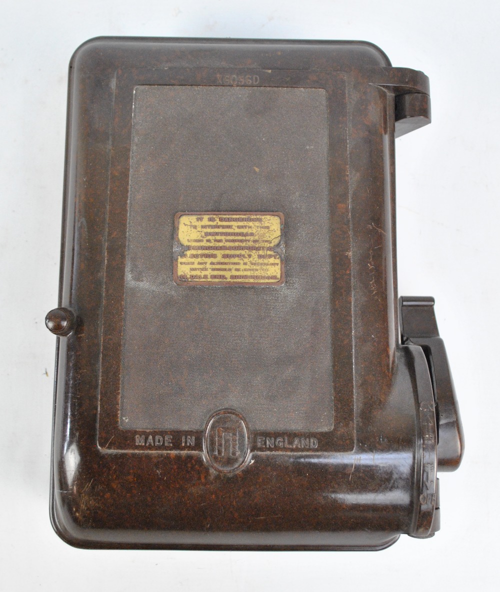 A brown bakelite fuse box (af).