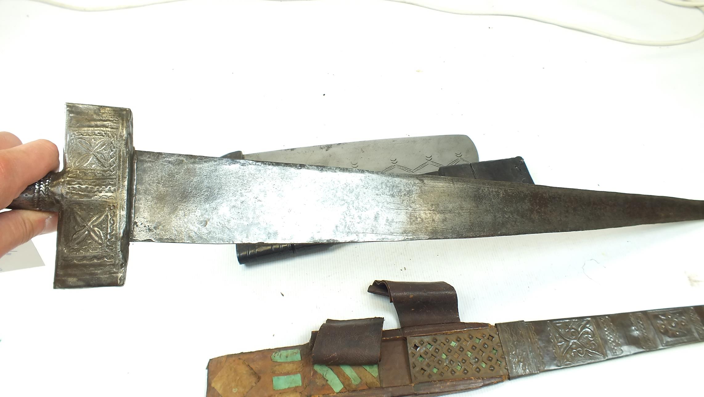 TWO VARIOUS NORTH AFRICAN SWORDS, the first with 73cm very broad ...