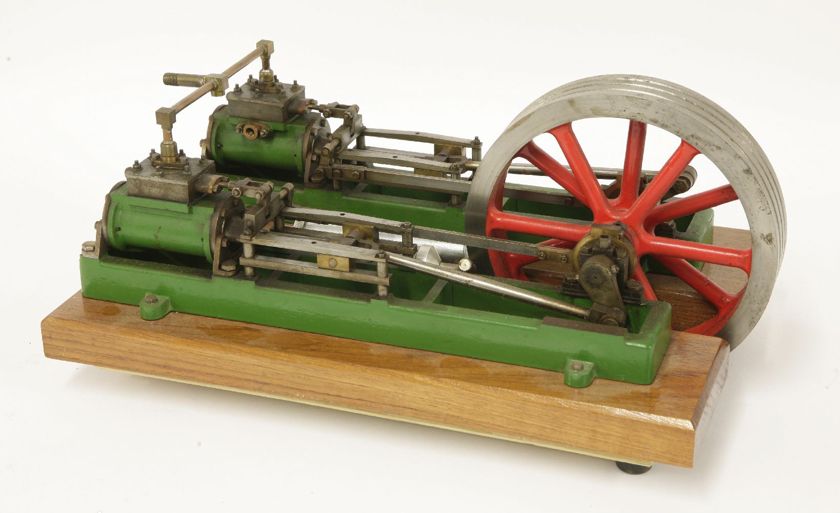 A model horizontal twin-pump steam engine,in green livery, mounted on ...