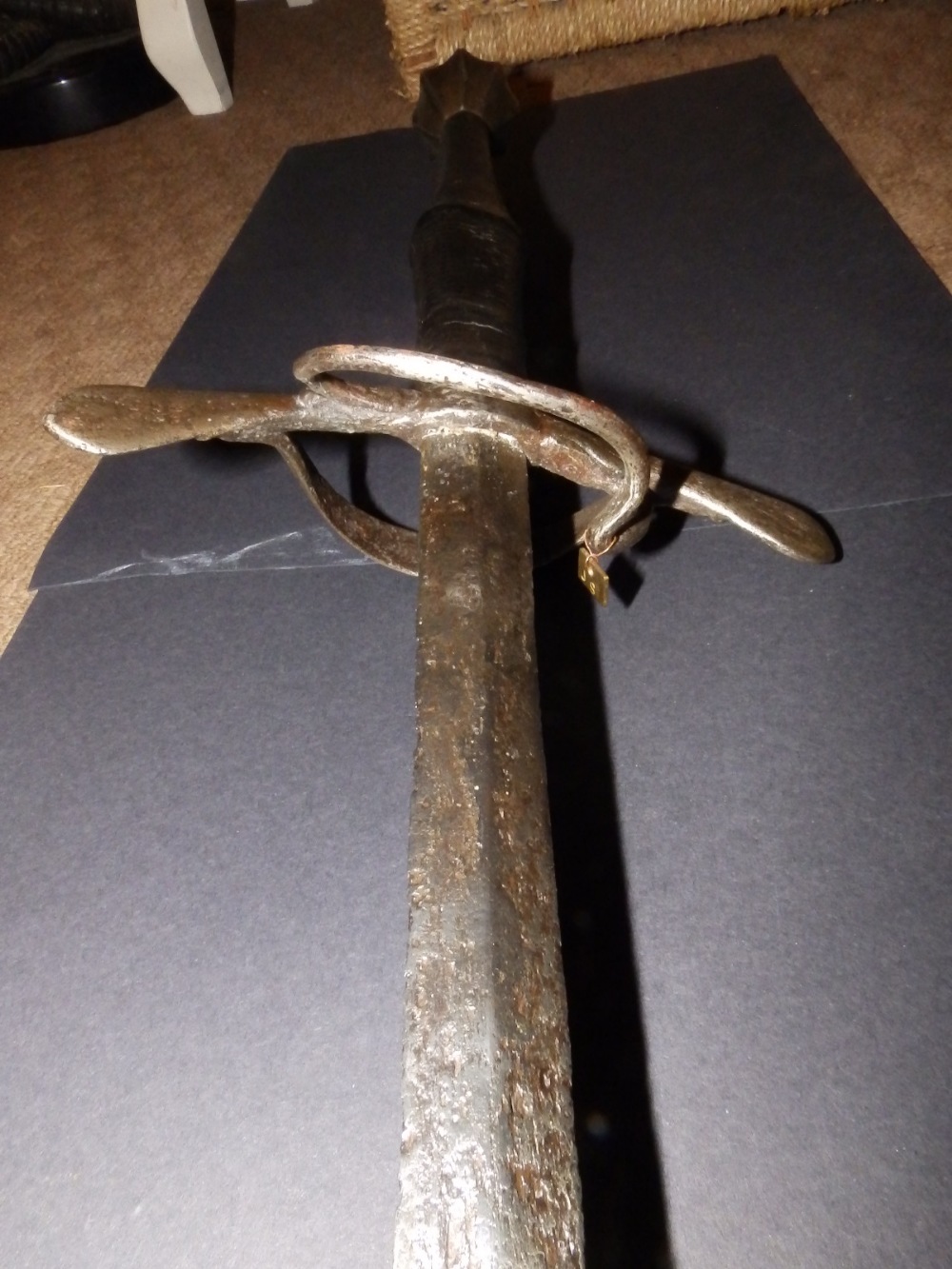 A 15thC two-handed broad sword with leather bound hilt, octagonal ...