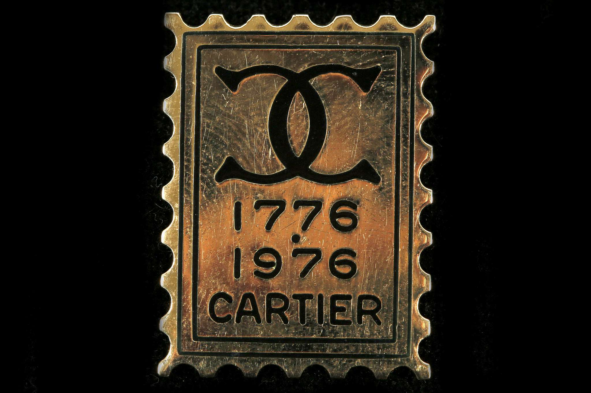 A 'Cartier' 18ct gold bicentennial stamp pendant with black enamelled ...