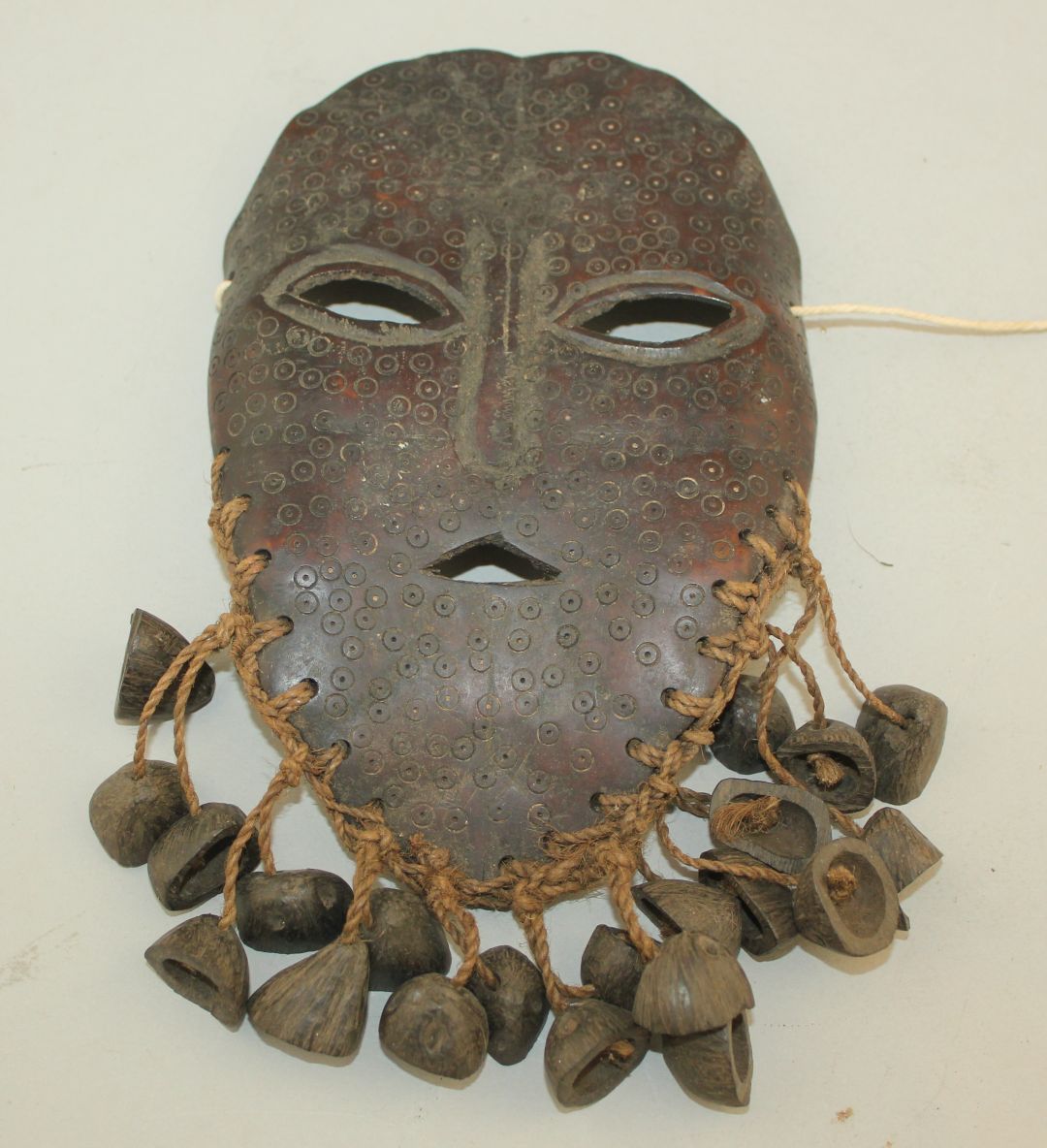 A tribal carved bone mask, probably African Democratic Republic of ...