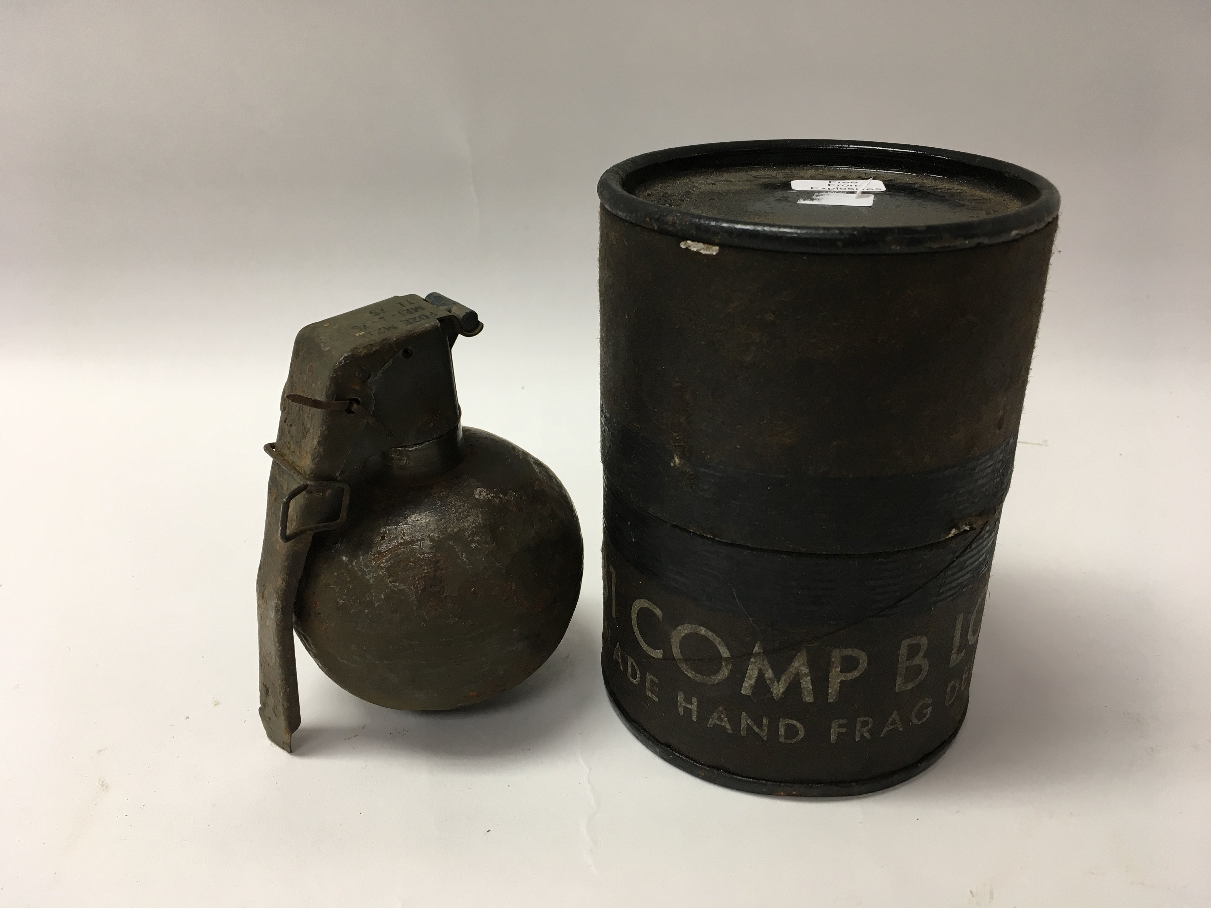 A Vietnam War style inert US M-67 Baseball grenade and transportation tube.