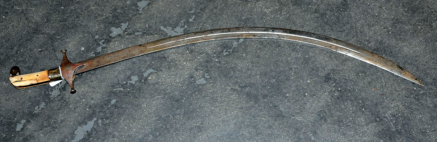 An antique Arabian Scimitar, with bone handle and decorated blade ...