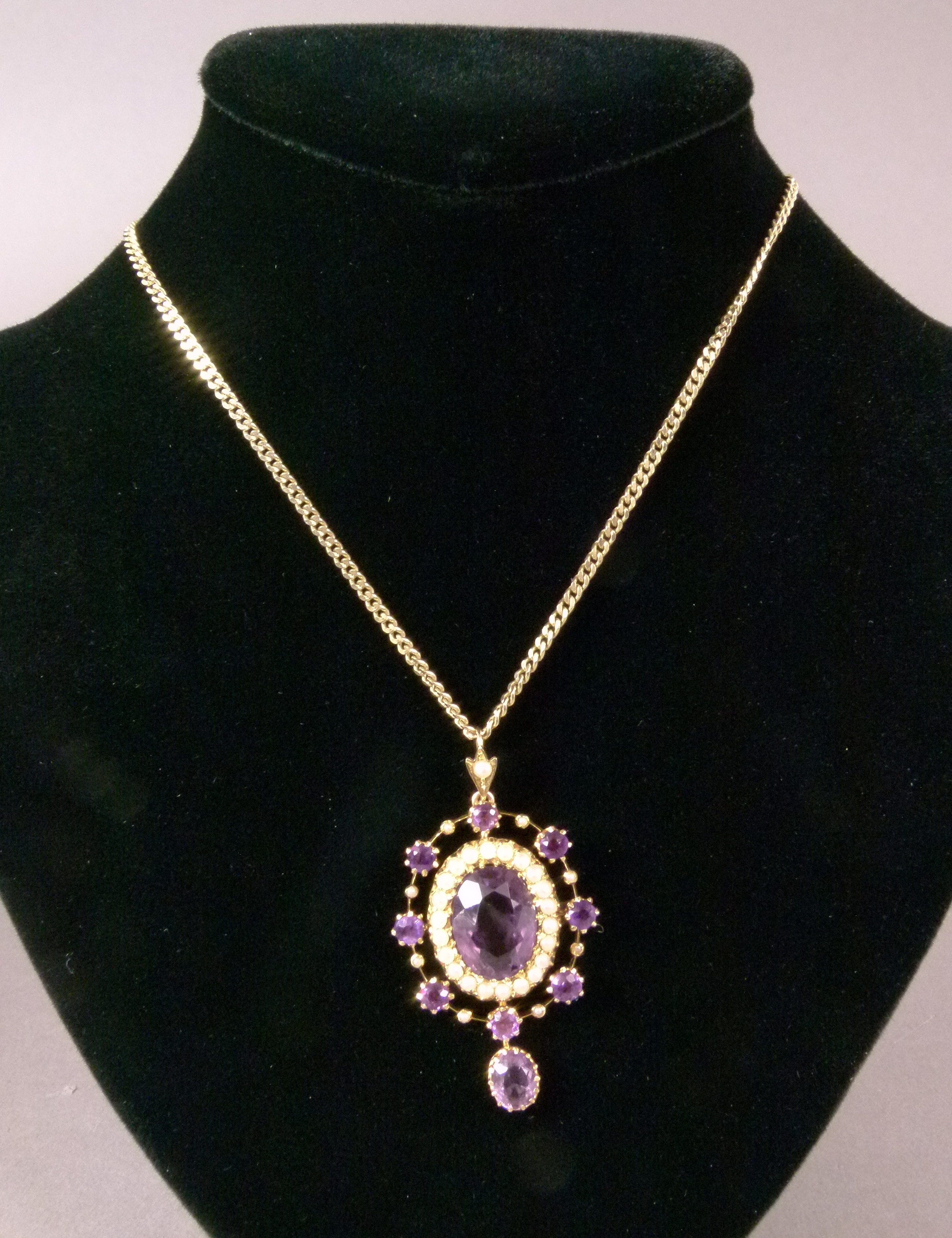 AN EDWARD VII AMETHYST AND SEED PEARL PENDANT in 9ct gold, the oval ...