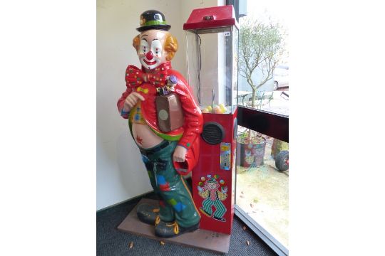 A LARGE VINTAGE CLOWN VENDING MACHINE.