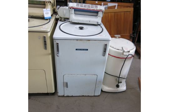 A vintage Hotpoint washer above two roll through wringer, with another ...