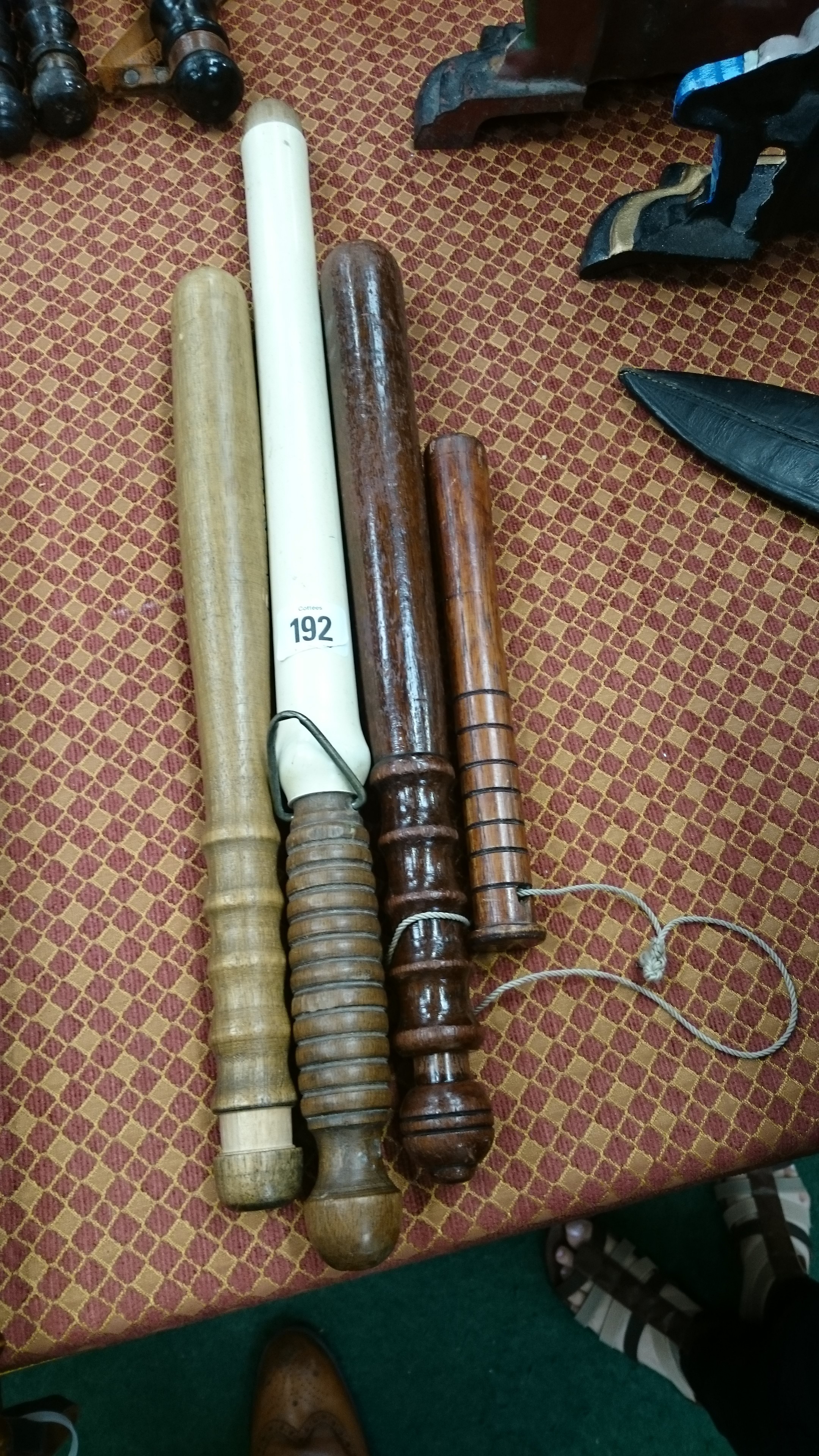 Three various wooden truncheons together with a Kukri.