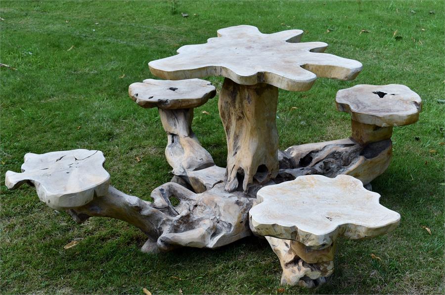 A large garden wood mushroom table and stools, H 81cm W 160cm D 175cm
