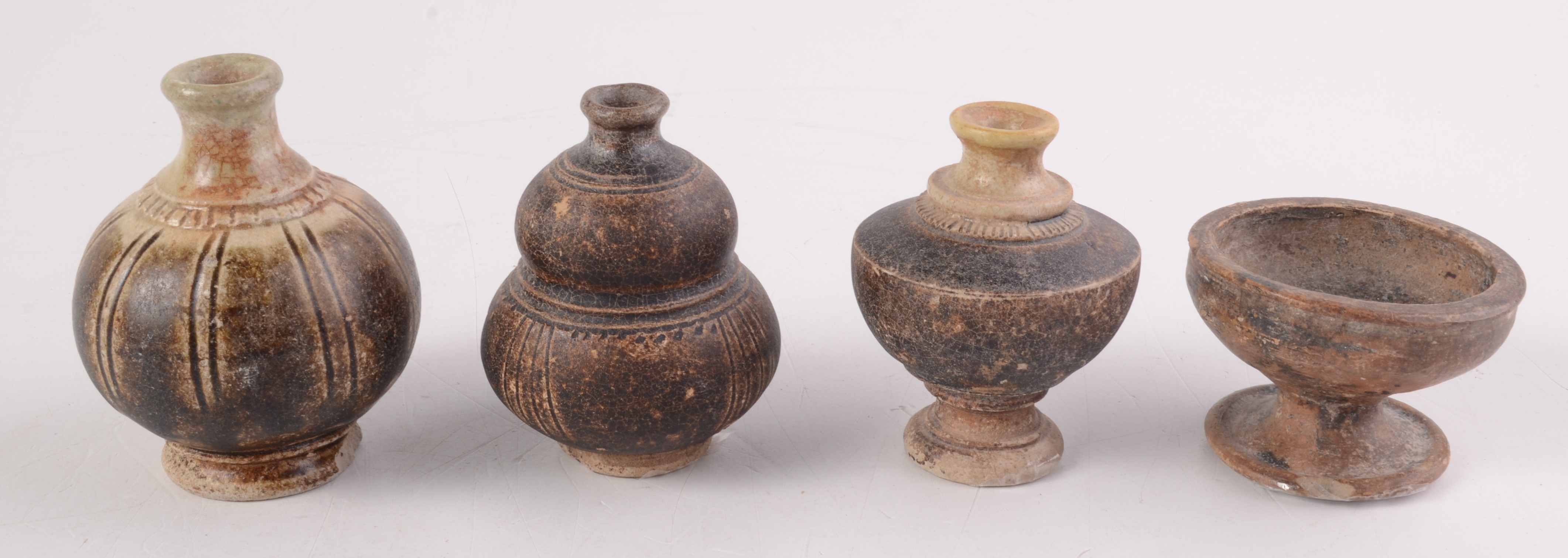 Khmer ceramics, four 12th-13th century brown glaze pots, heights 8.5cm ...