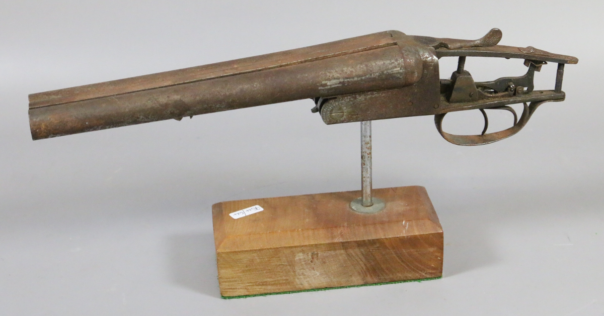 A desk top cross section of side by side shotgun action.