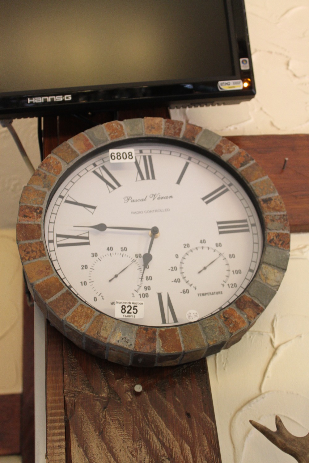 Pascal Veran wall clock mounted in slate and stone surround