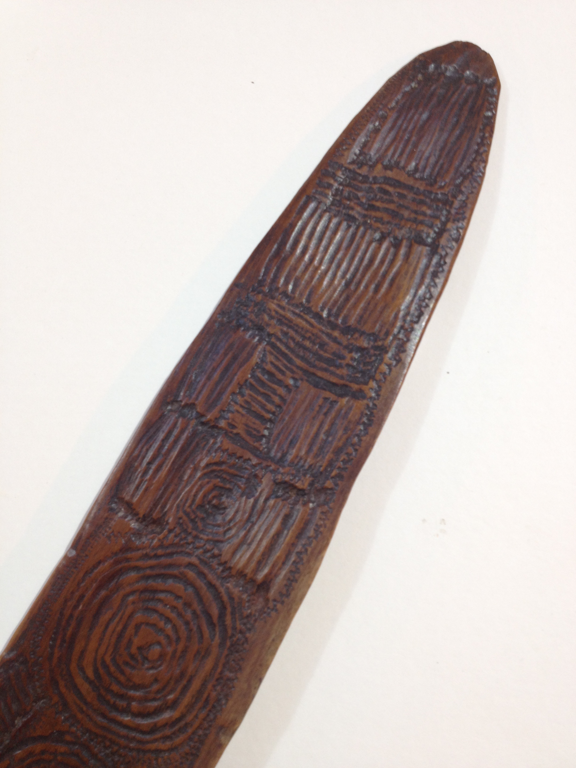 An Aboriginal shield of typical form with carved geometric patterns ...