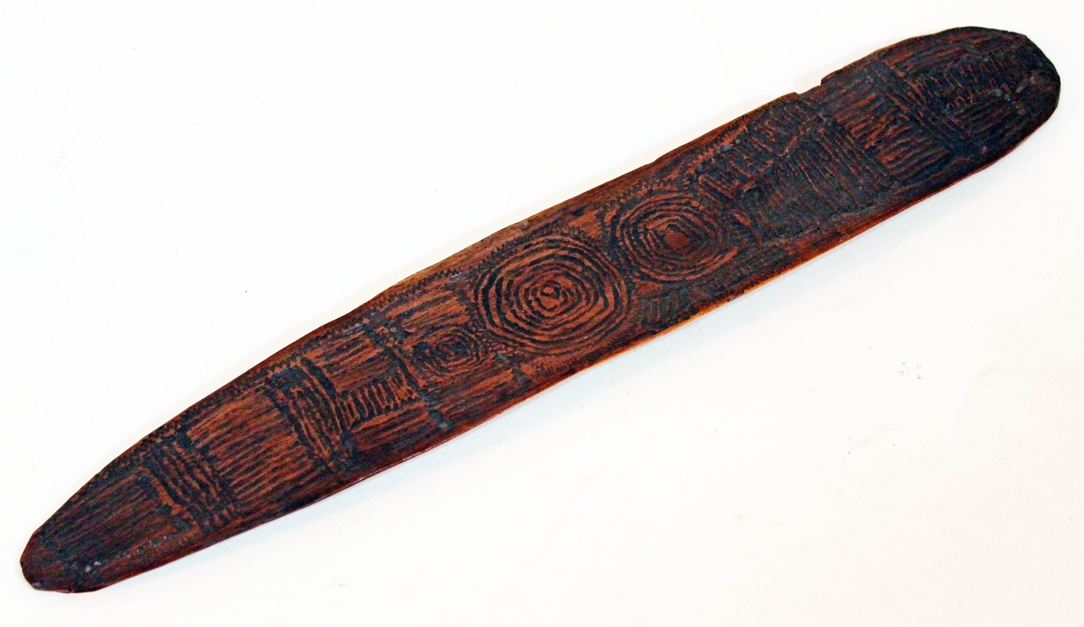 An Aboriginal shield of typical form with carved geometric patterns ...