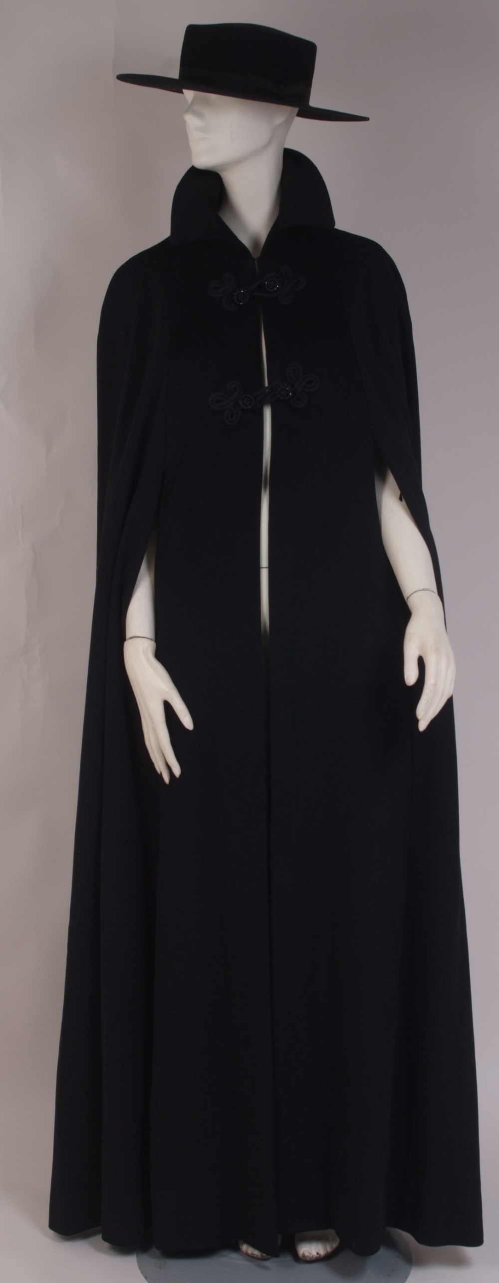 A VINTAGE BLACK WOOL CLOAK & BLACK FELT SPANISH HAT A full length soft ...