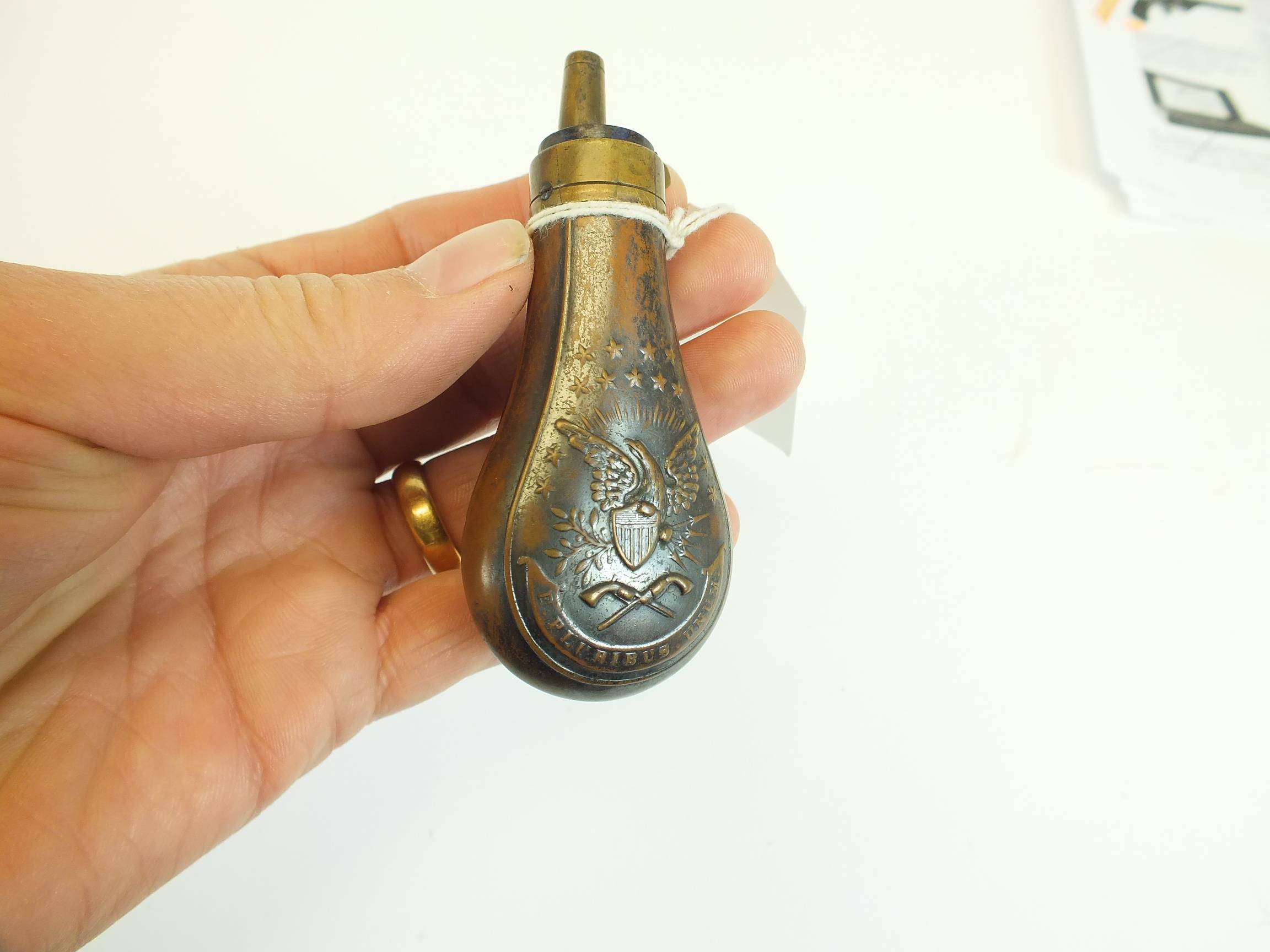 A REMINGTON OR COLT EMBOSSED POWDER FLASK, the pear-shaped copper body ...