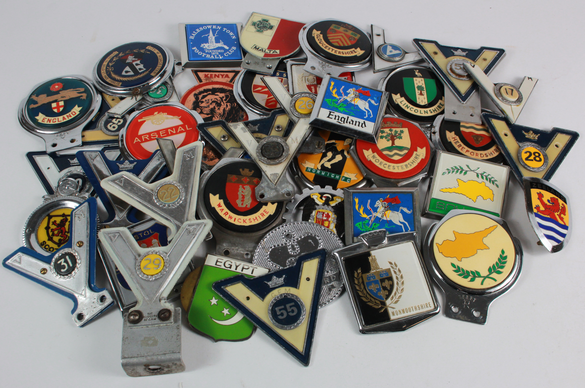 Car badges. A collection of approximately forty-five car badges ...