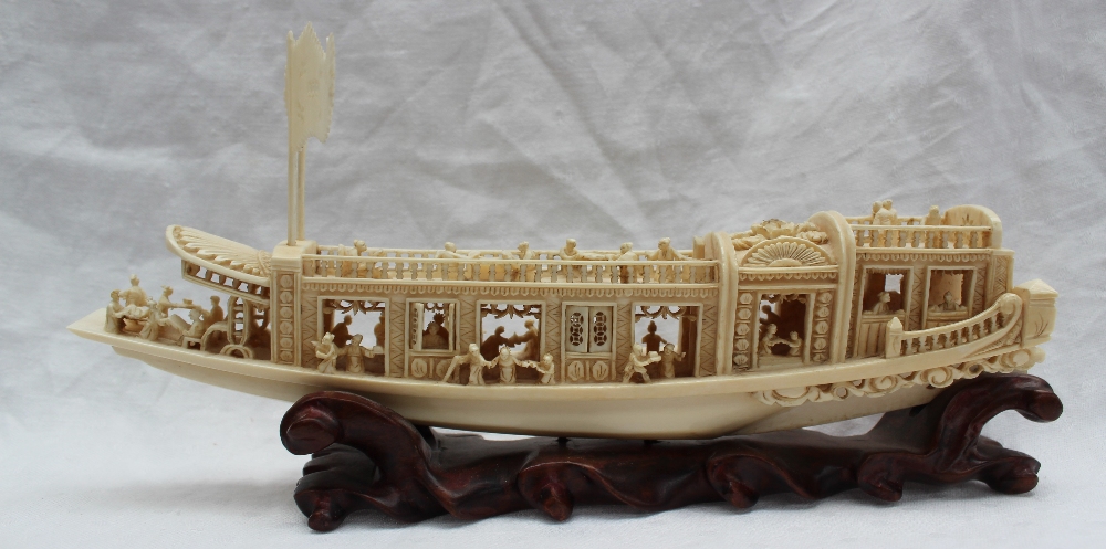 An early 20th century Chinese carved ivory boat, profusely carved with ...
