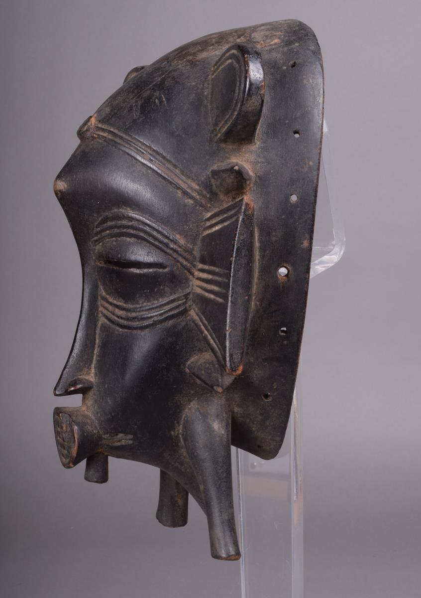A Senufo kpelie mask, Ivory Coast, carved wood, 25cm high. Provenance ...