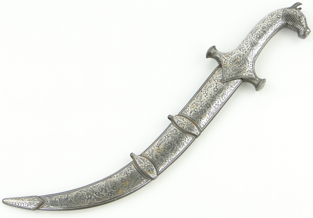 A 19th century Middle Eastern curved dagger, with ornate silver inlaid ...