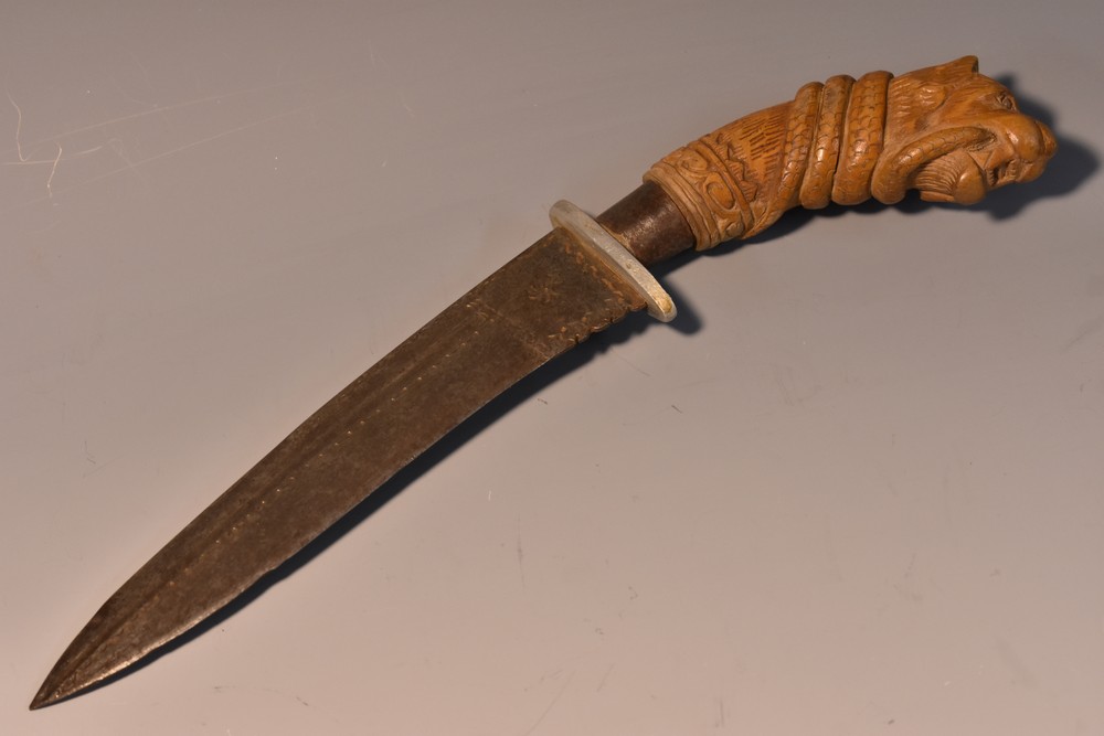 An Indian dagger, 17cm slightly serpentine blade, wooden grip carved ...
