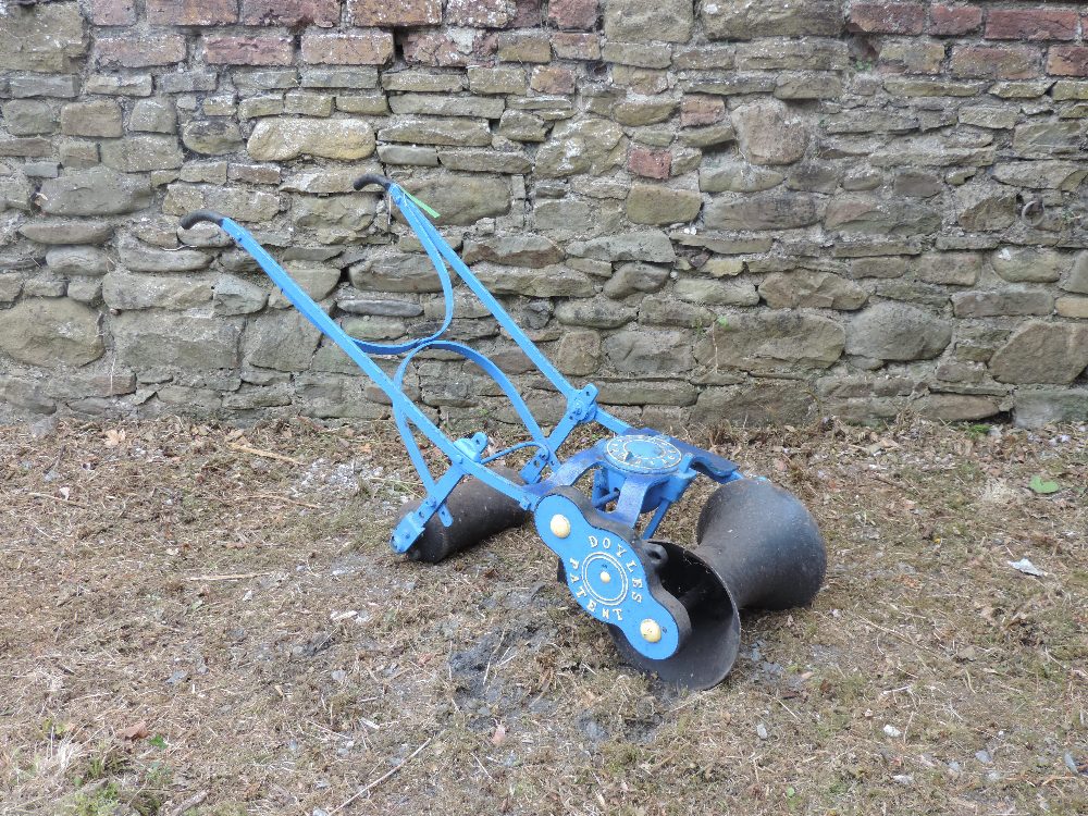 An antique metal Turnip Machine, by W. Doyle, Wexford, painted blue and ...