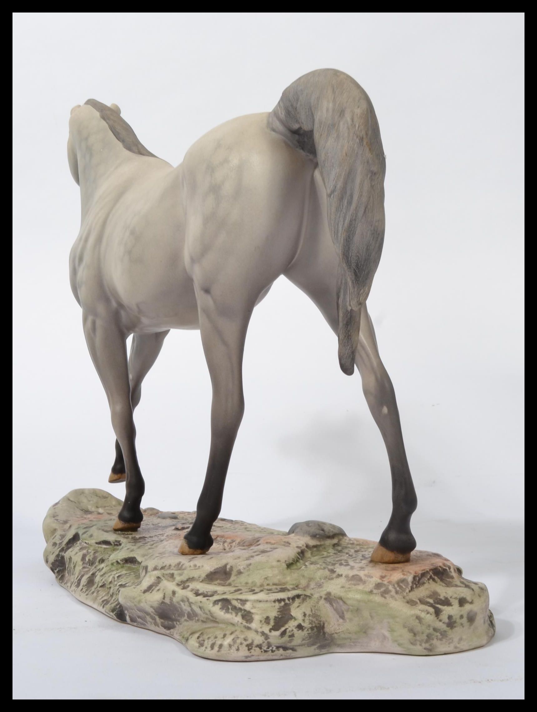 A large Beswick figurine of a horse in a white and grey dappled ...