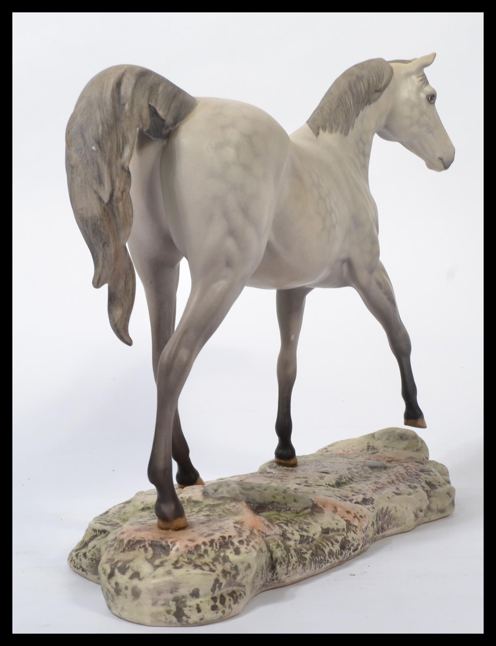 A large Beswick figurine of a horse in a white and grey dappled ...