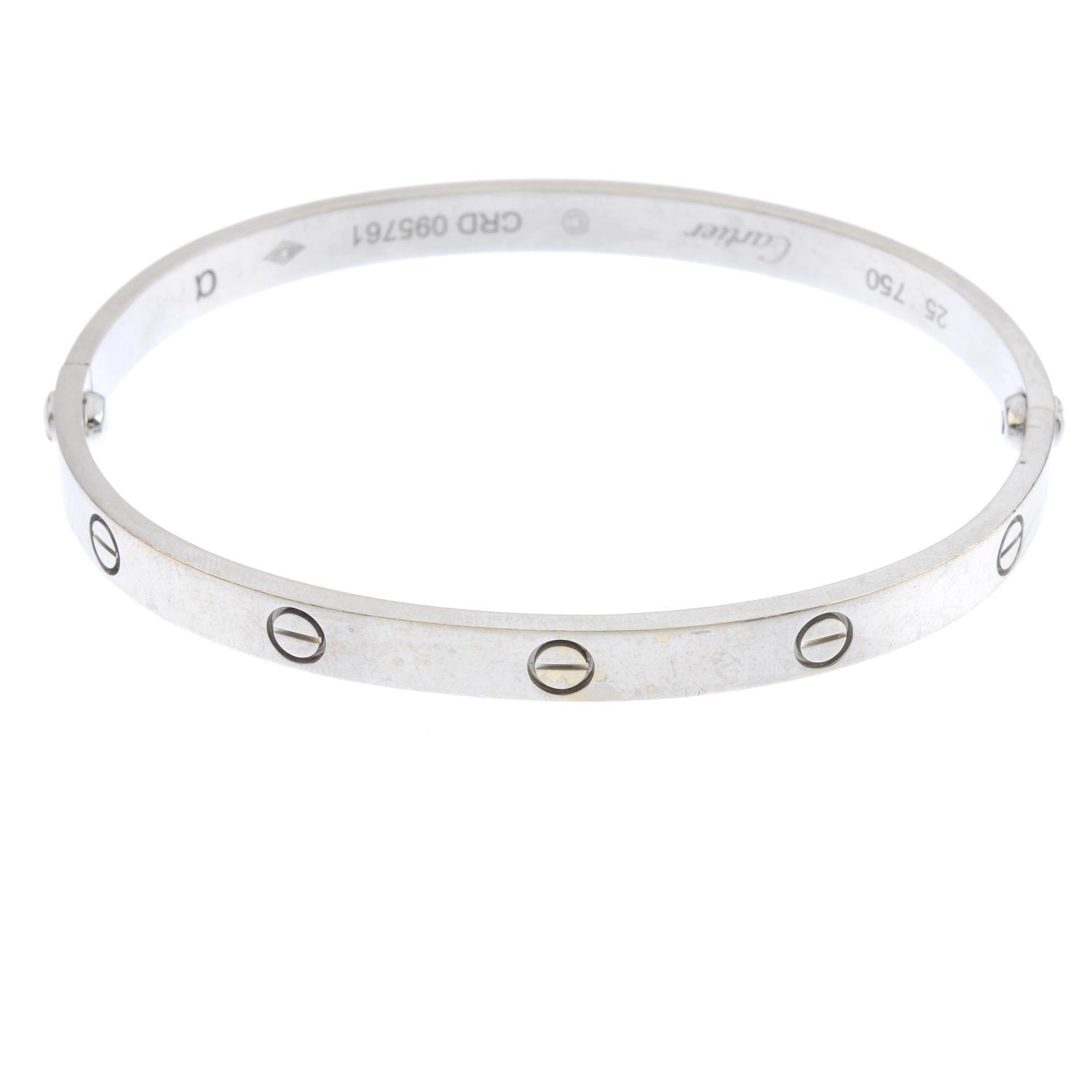 CARTIER - a 'Love' bangle. The polished bangle, with screw head motifs ...