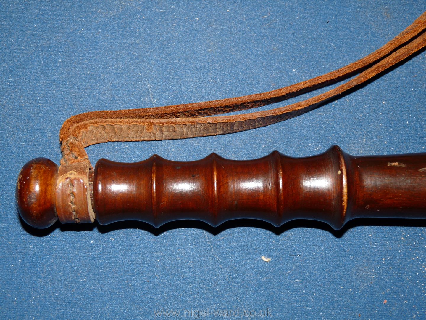 A policeman's turned wooden truncheon with leather wrist strap reputed ...