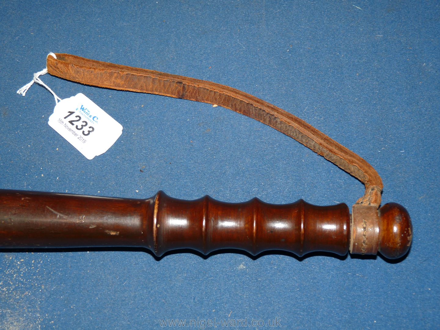 A policeman's turned wooden truncheon with leather wrist strap reputed ...