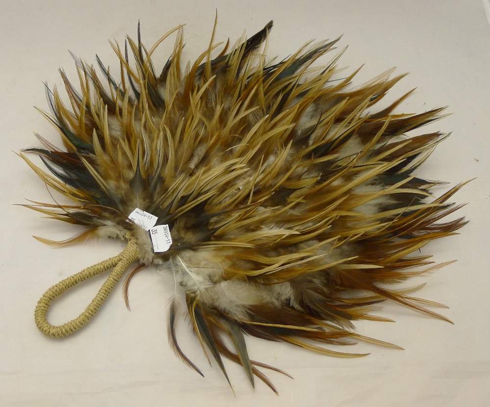A Maori Kiwi feather fanApproximately 43 cm wide. CONDITION REPORTS ...