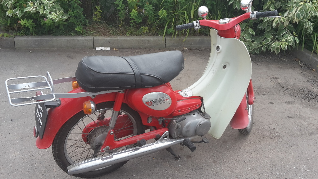 A 1970 Suzuki U50 step through, registration number HGL 977H, red. The ...
