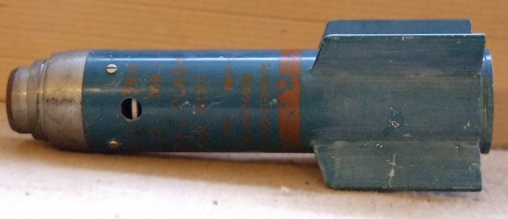 Two 25lb US practice bombs, Mk. 76, emitting smoke and/or flash on ...