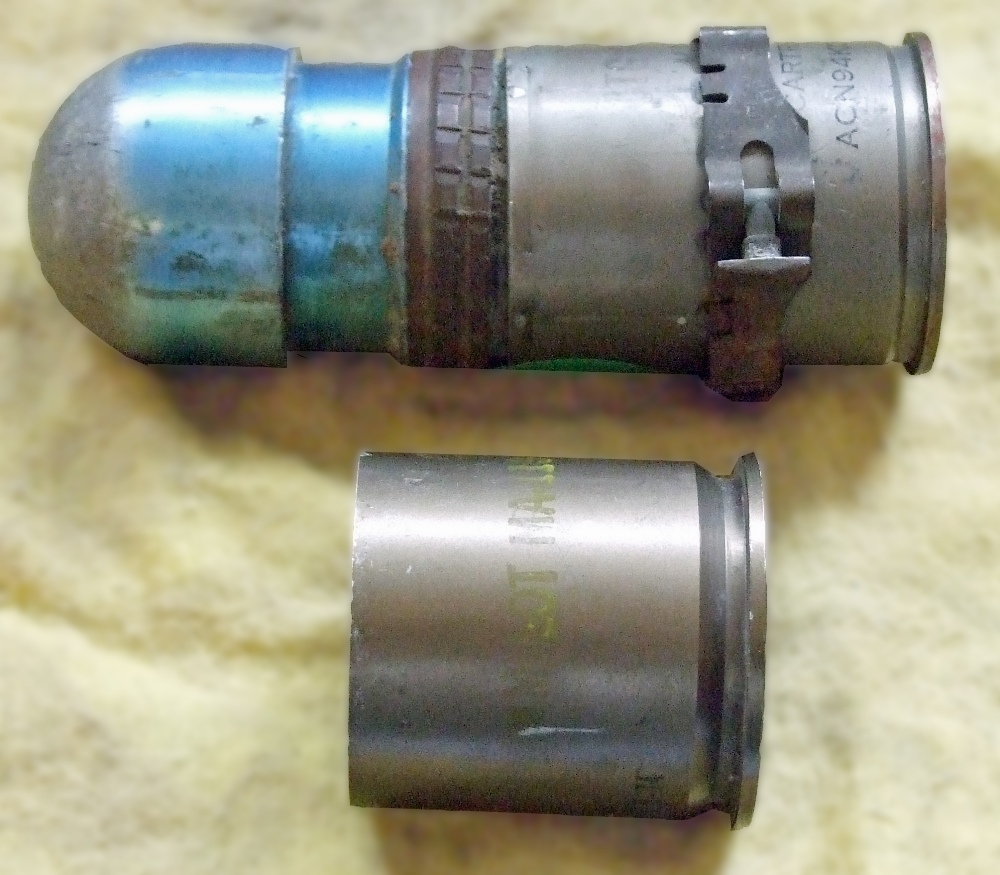 A 40mm grenade launcher round, a fired practice round and fired ...