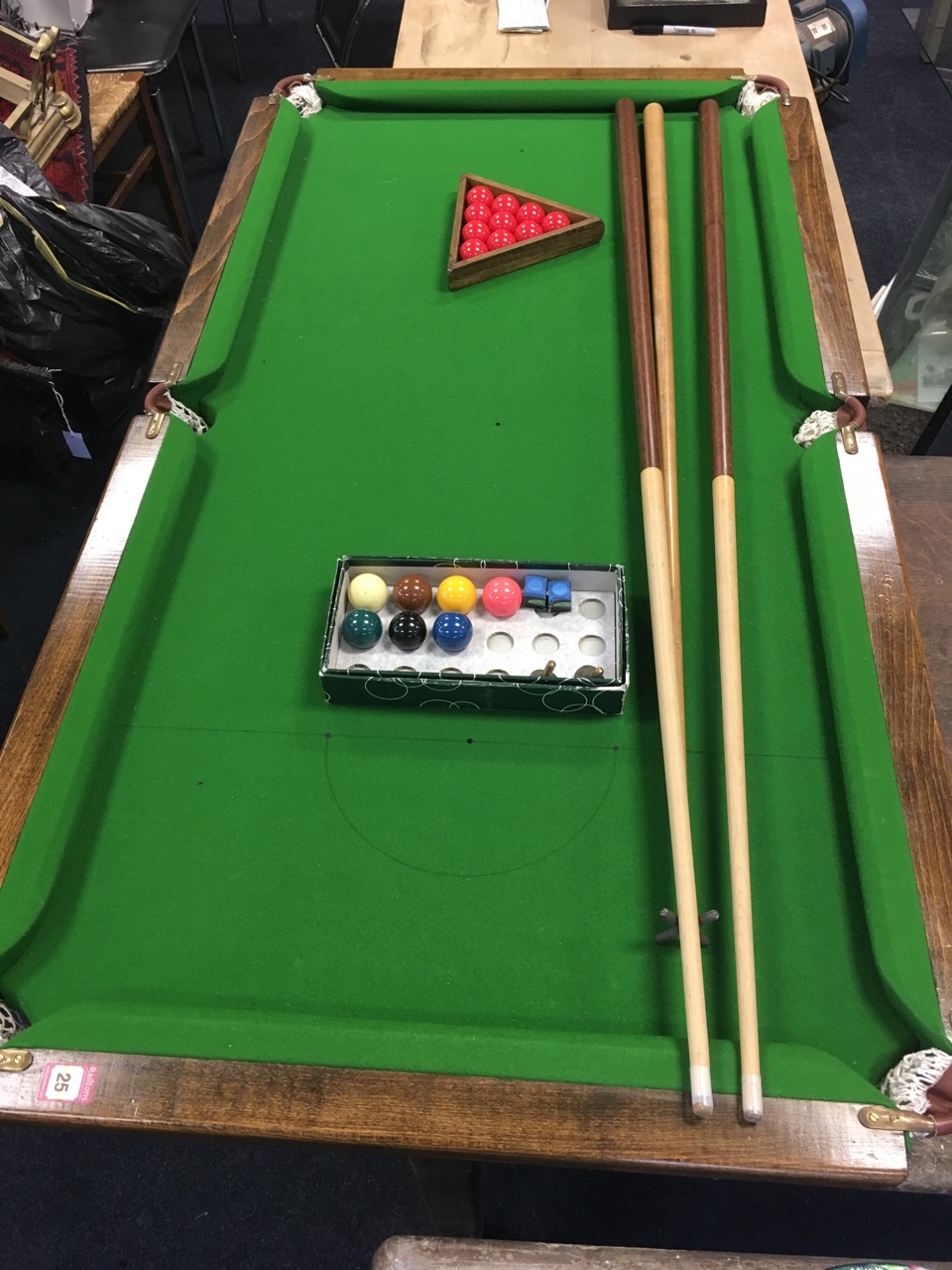 A tabletop snooker table complete with cues, a set of balls, triangle ...