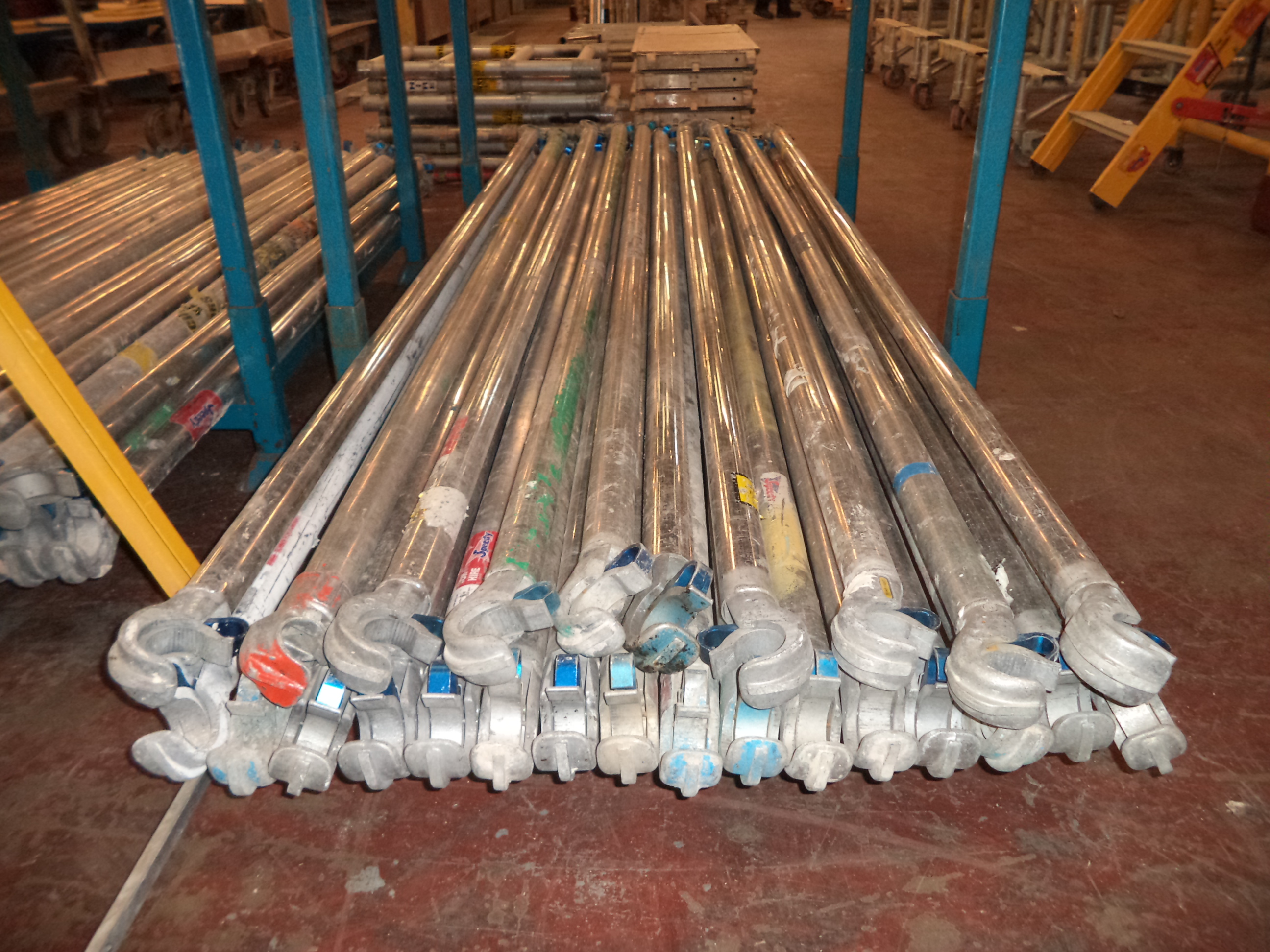 Circa 26 scaffold poles with attachments at each end, each pole having ...