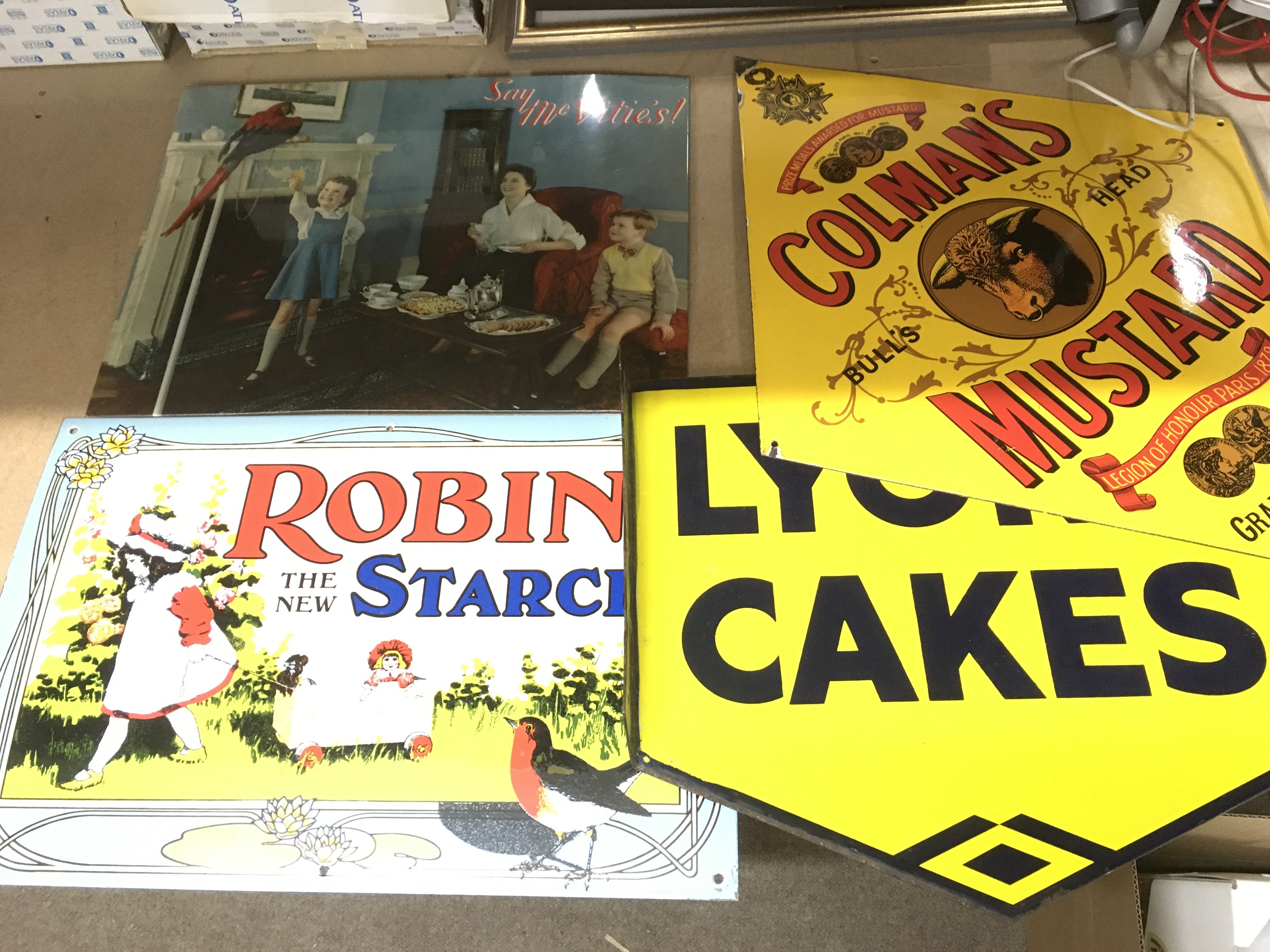 Four vintage enamel advertising signs.