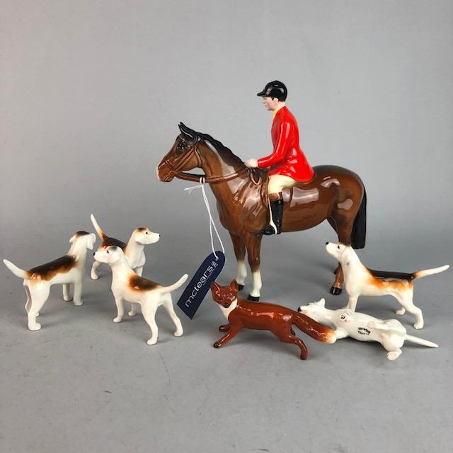 BESWICK FOXHUNTER FIGURE, 21cm high, along with six fox hound figures (7)