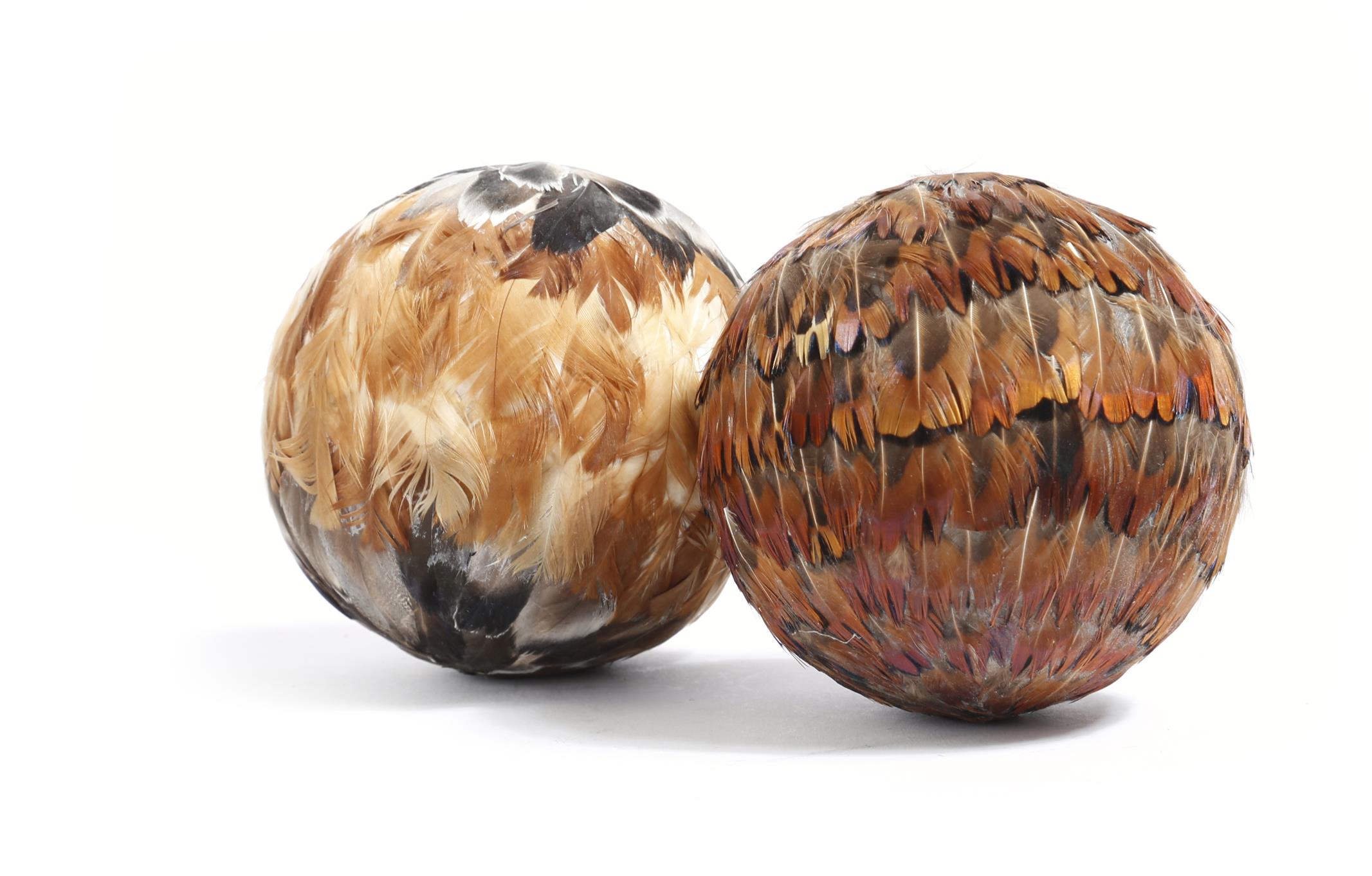 Two feather balls, 9.5cm diameter. (2) Provenance: The collection of ...