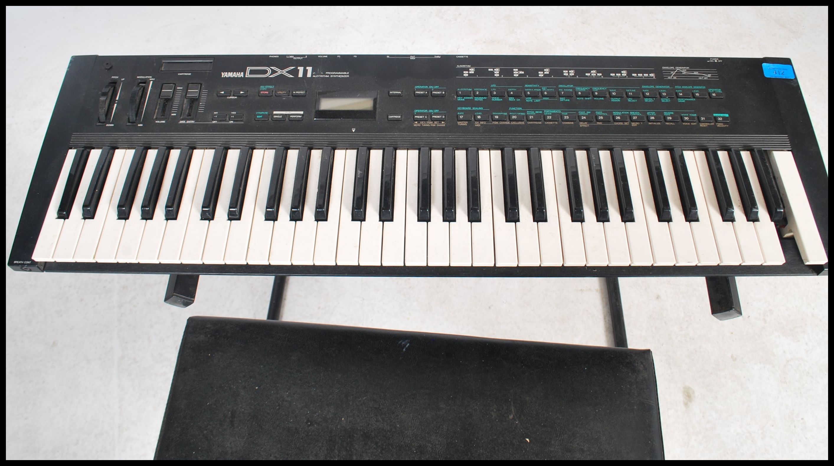 A retro 1970's Yamaha DX - 11 synthesizer / keyboard, with stand and ...